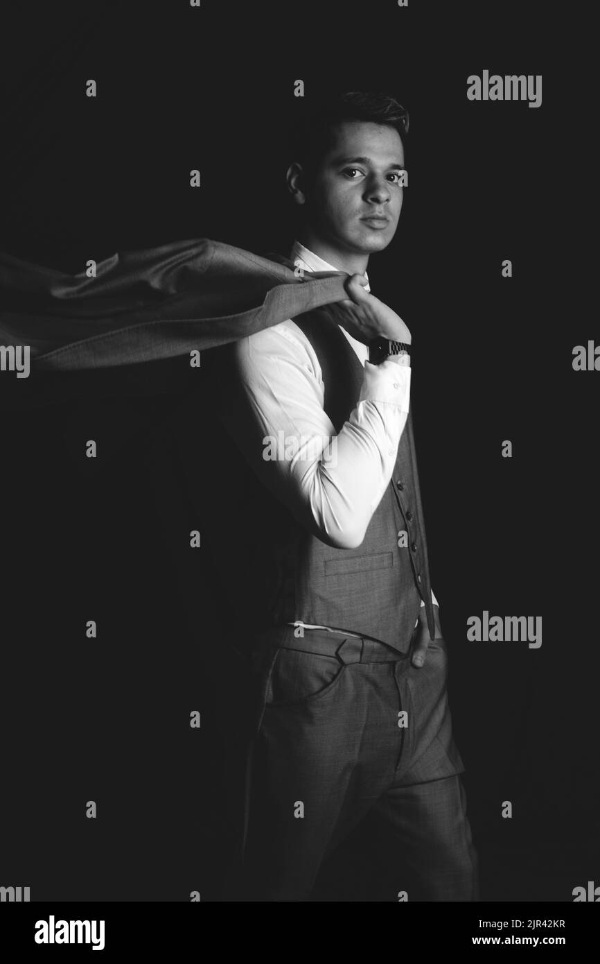 Model in elegant suit posing. Model dressed in a suit and the sack on ...