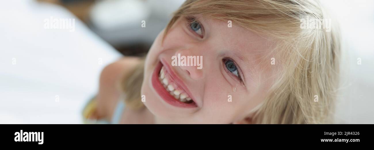 Portrait of little smiling girl with tears and blond hair Stock Photo ...