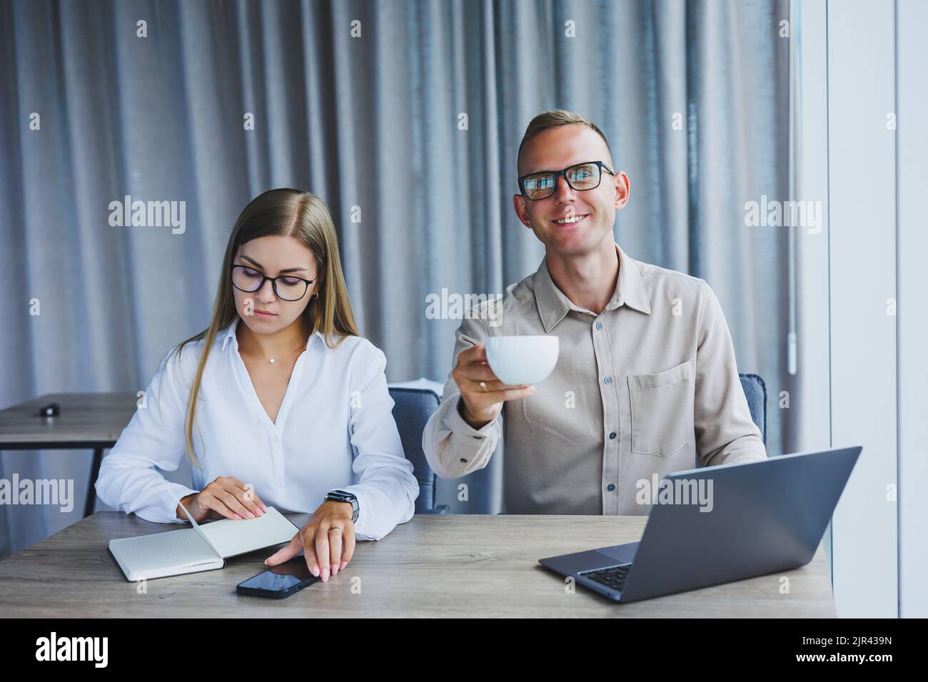 Young business team, male and female colleagues talking at work ...