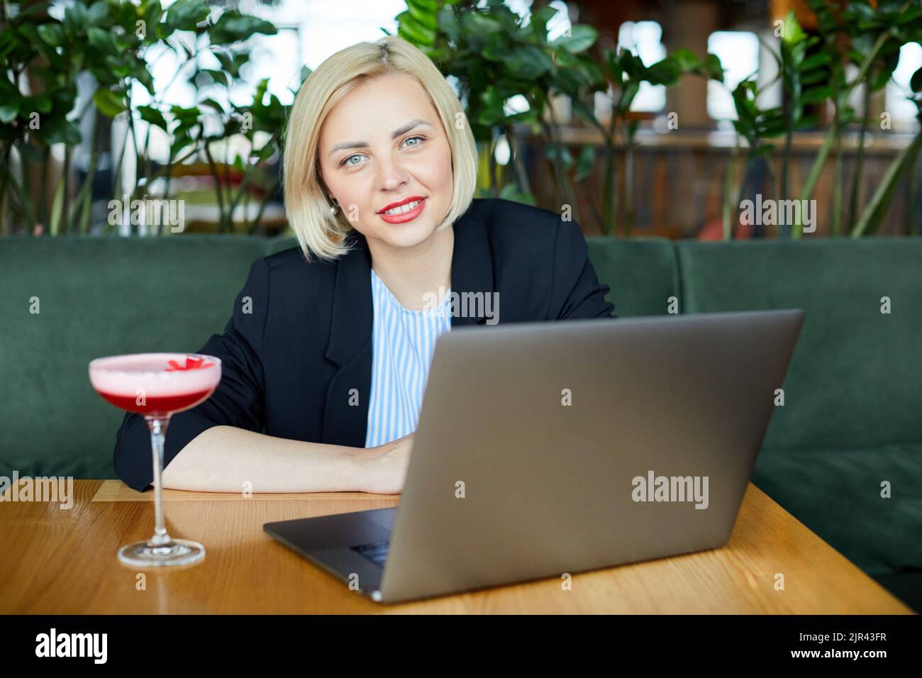 Picture of inspired attractive model writing at her laptop, spending ...