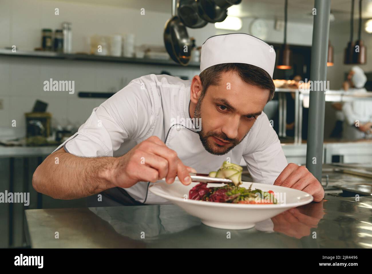 Chef preparing salad in the modern kitchen of restaurant. Tasty and ...