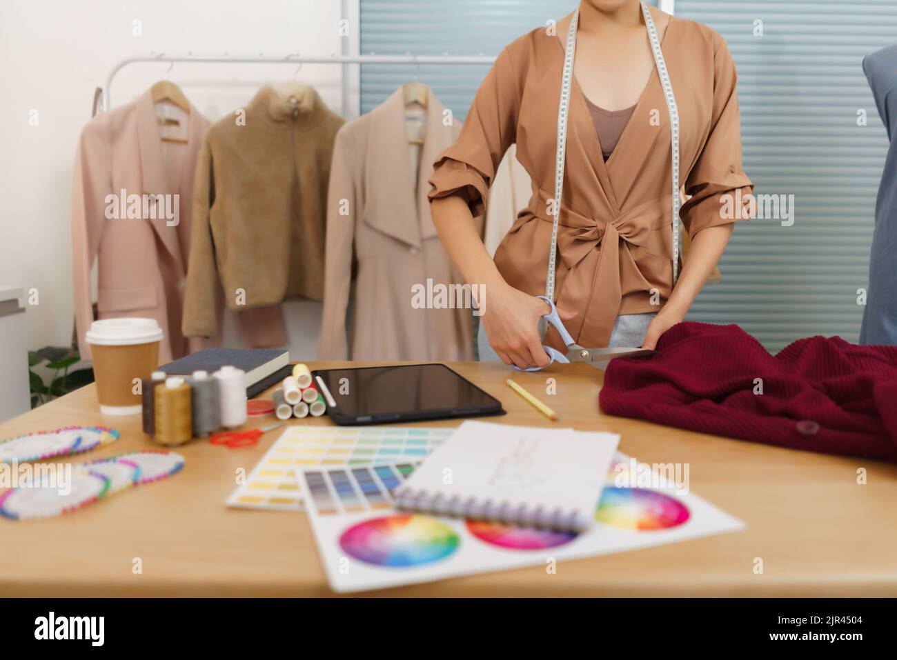Fashion design concept, Asian female fashion designer is tailoring ...