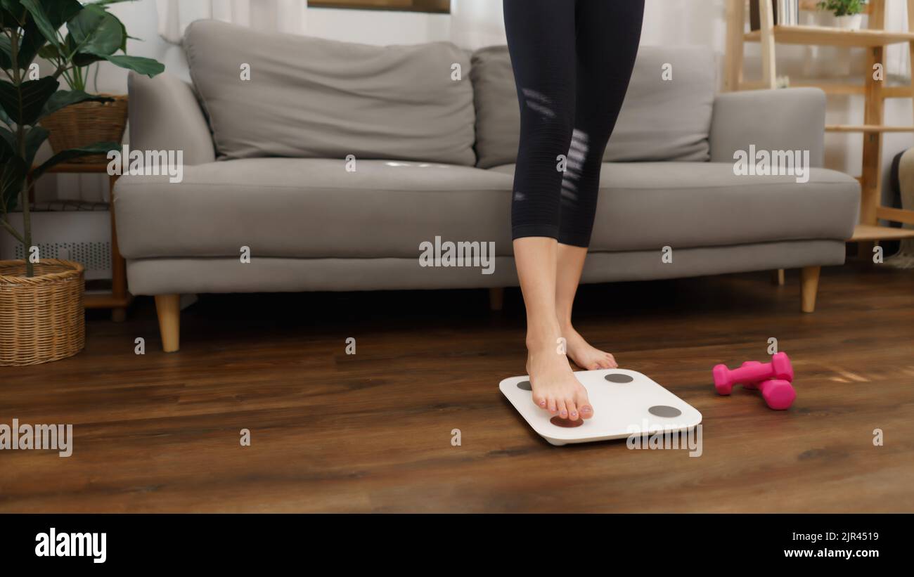 Healthy and weight loss concept, Young Asian woman stepping on weighing ...