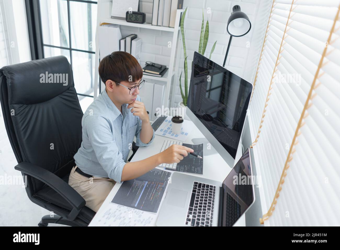 Software development concept, Male programmer pointing on laptop screen to checking data codes ...