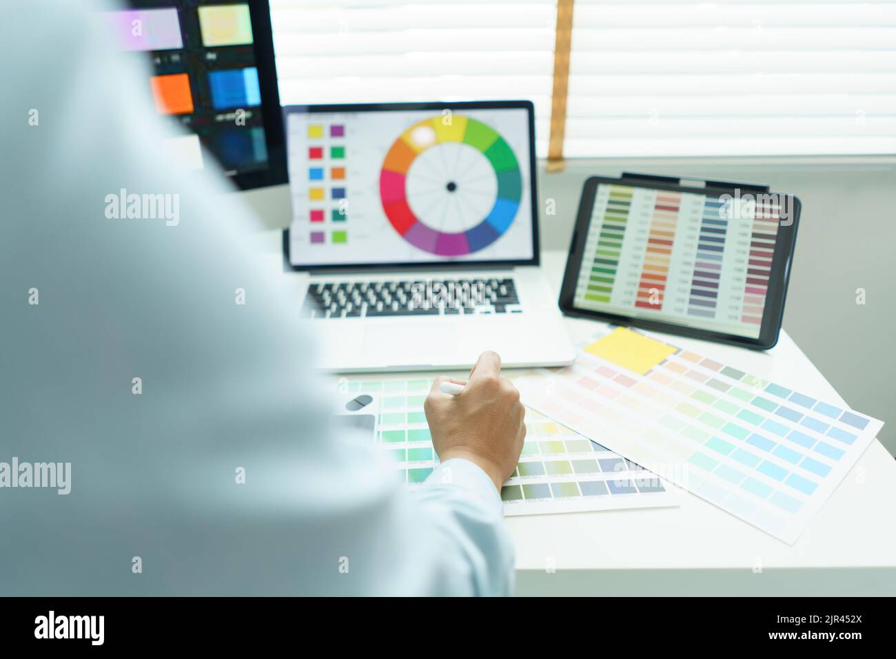 Creativity concept, Male graphic designer choosing color swatch samples ...