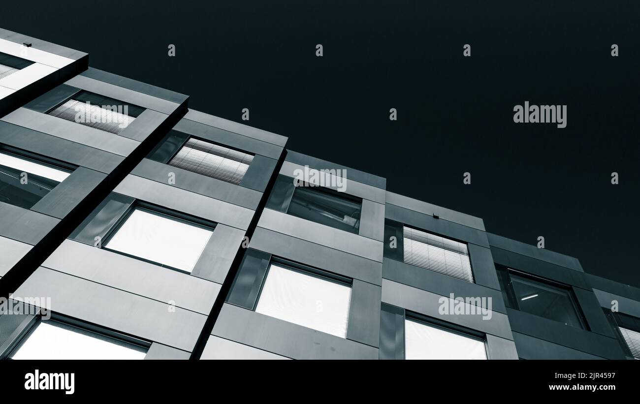 Thw walls of a futuristic modern building in a city with sunlight ...