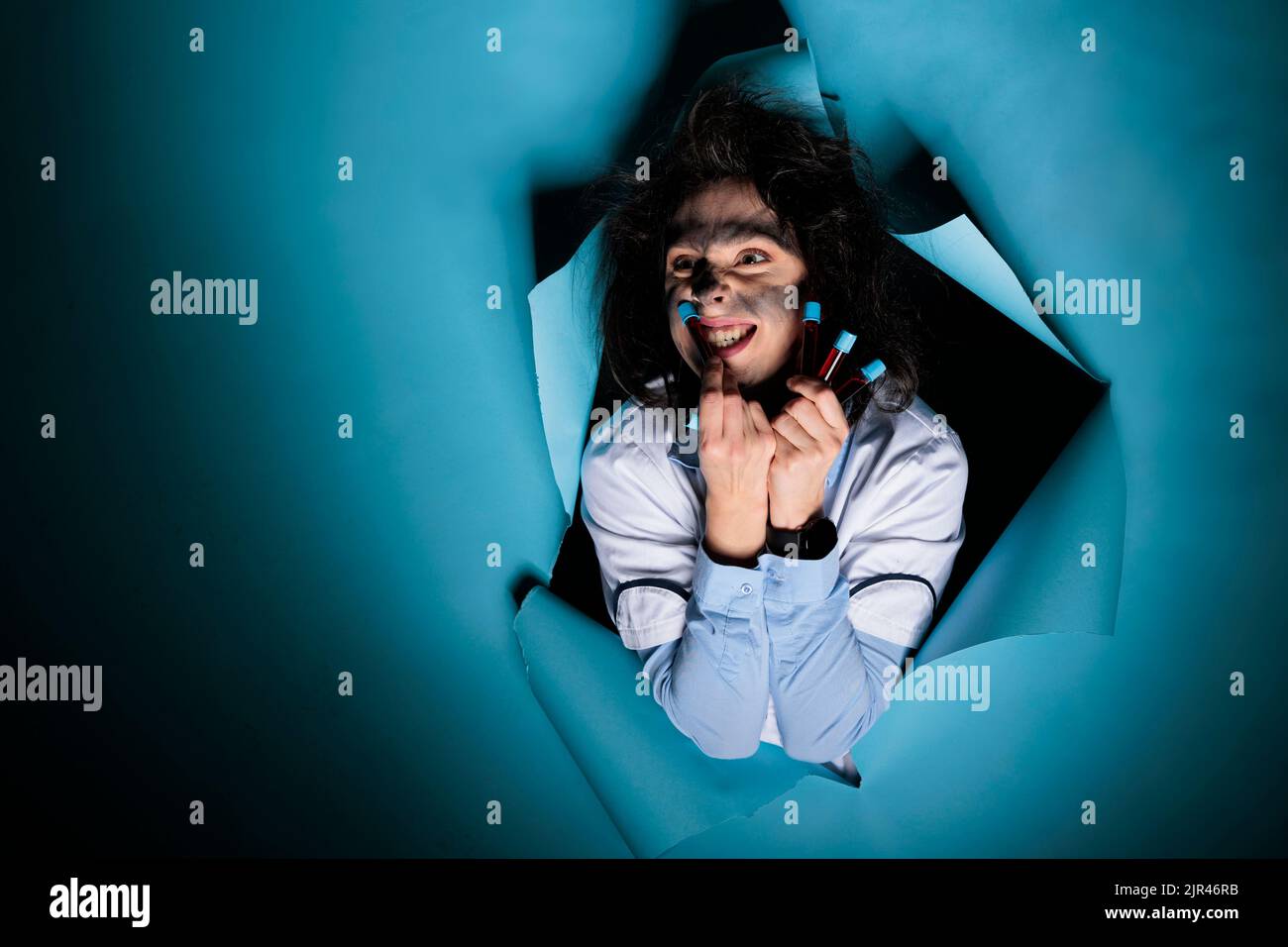 Mad scientist with messy hairstyle and filled glass test tubes grinning ...