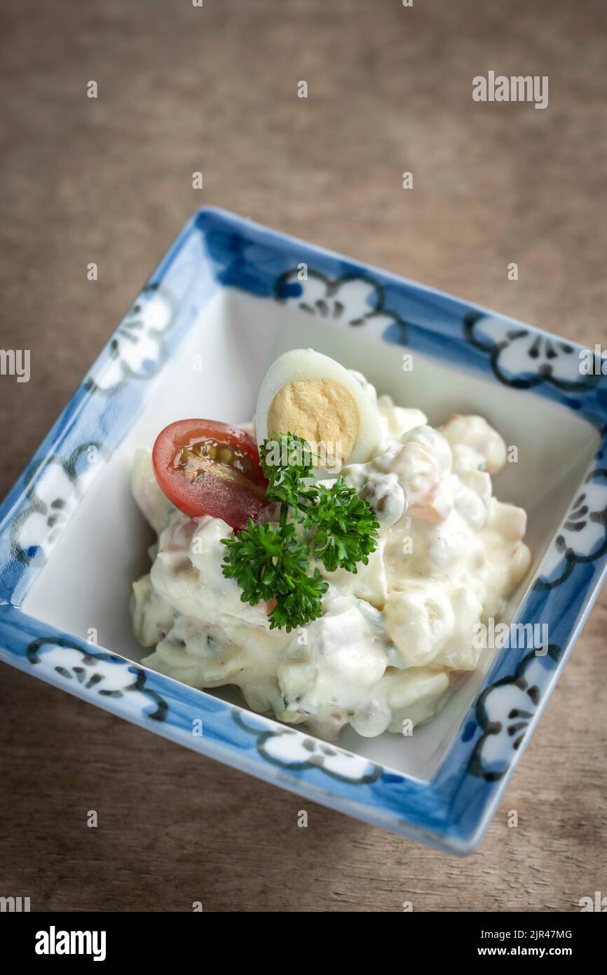 potato and egg salad Ensalada Rusa tapas in rustic spanish restaurant ...