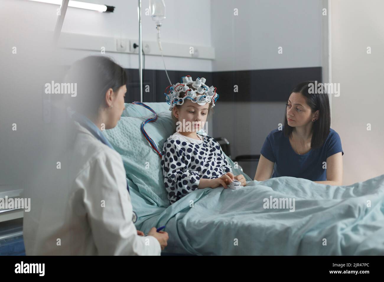 Pediatric hospital ward neurology specialist examining hospitalized ...