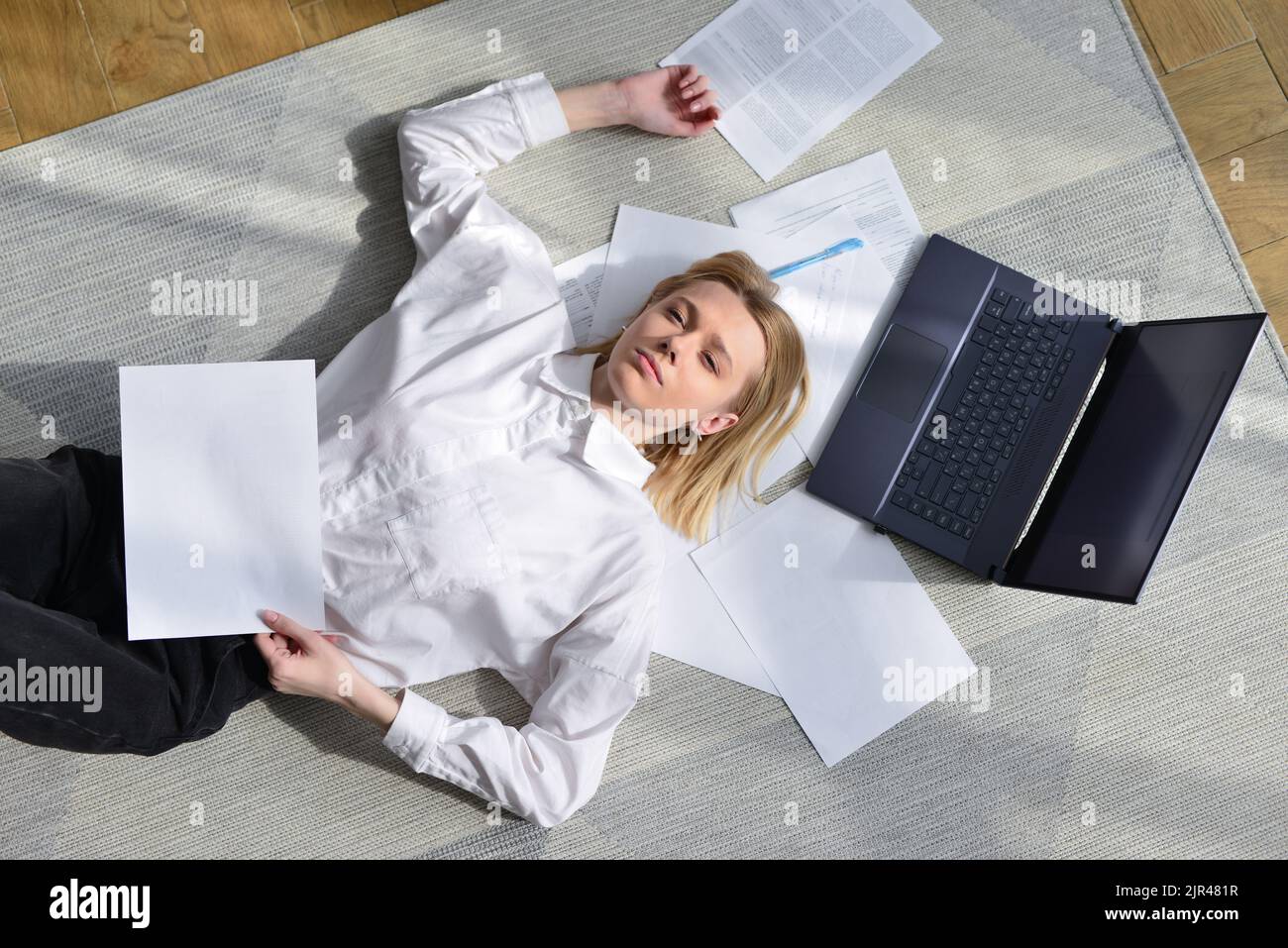 Work weary woman lying on floor Stock Photo - Alamy
