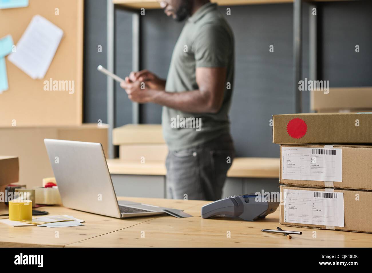 Horizontal image of workplace with laptop and cardboard boxes on it ...