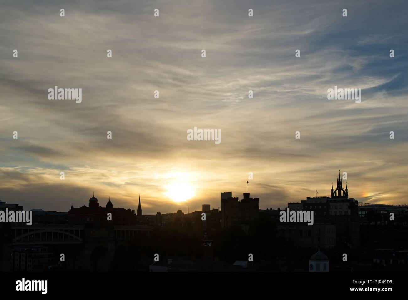 Almost in silhouette, the city skyline of Newcastle upon Tyne in North ...