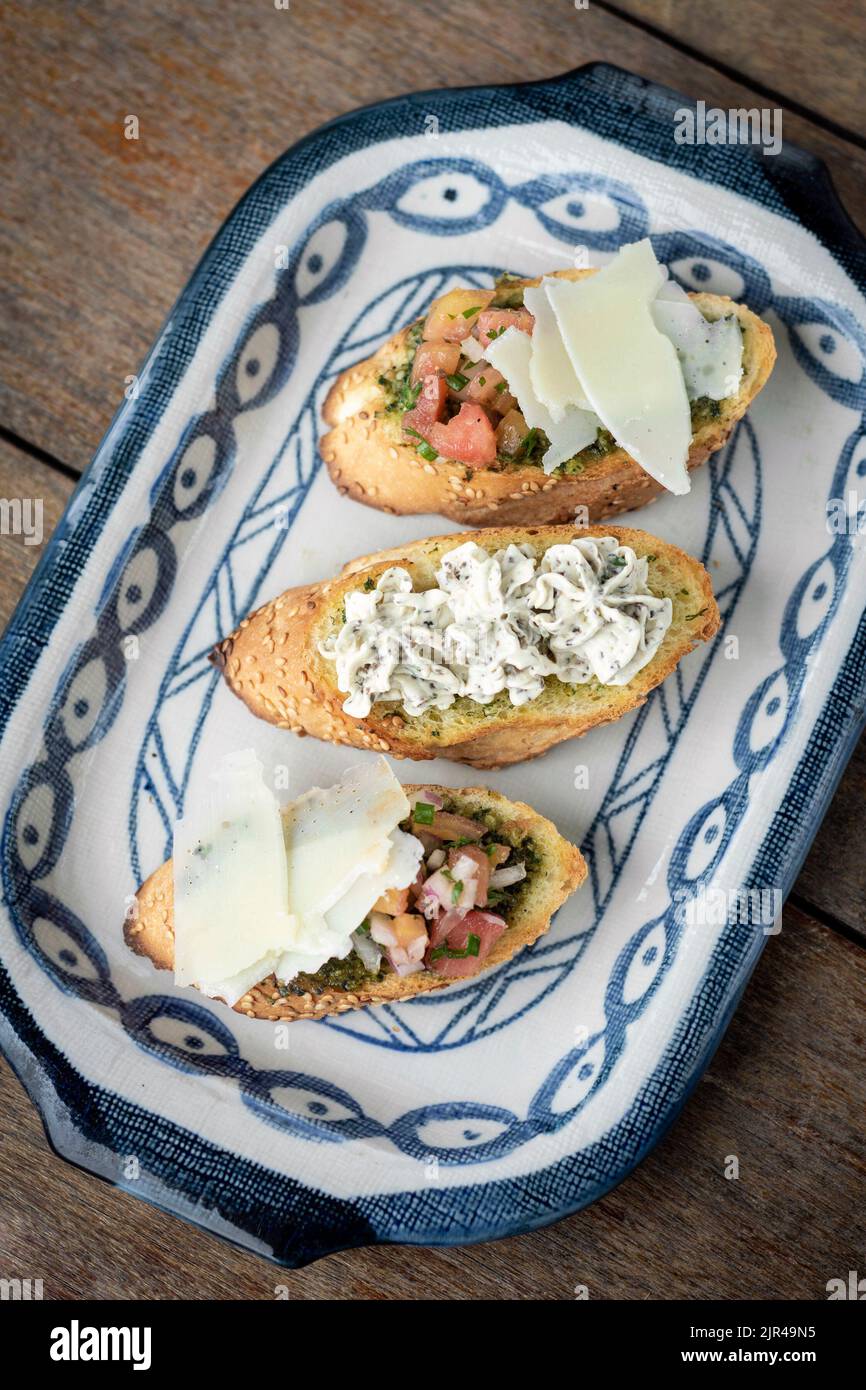tapas with Bruschetta and creamed herb cheese on toast in rustic ...
