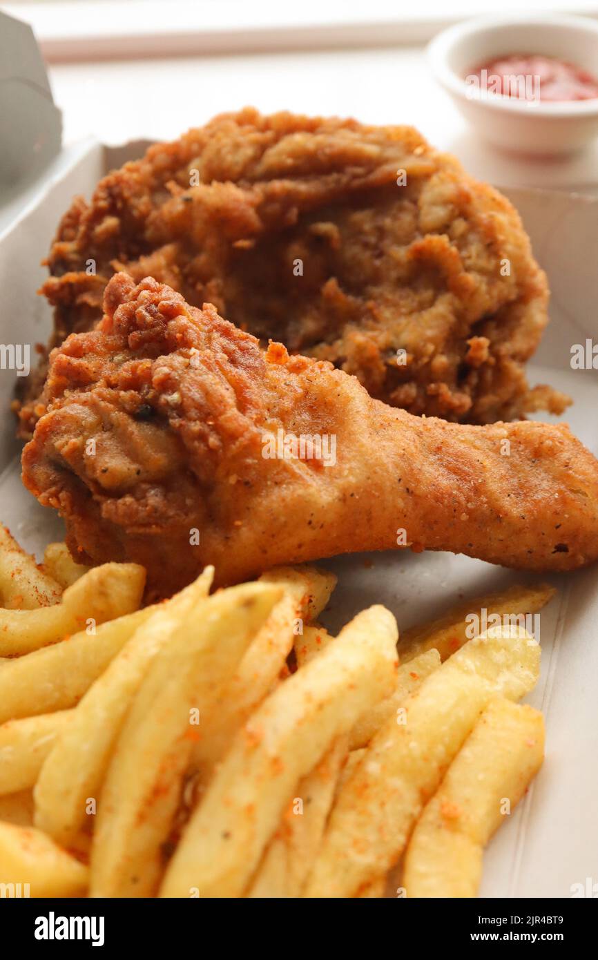 Battered fried chicken and chips. Fried chicken with a side of hot ...