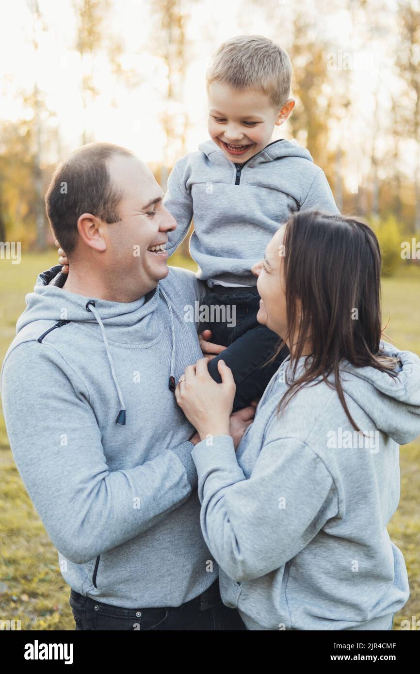 Happy caucasian family hugging while posing together. Active kid ...