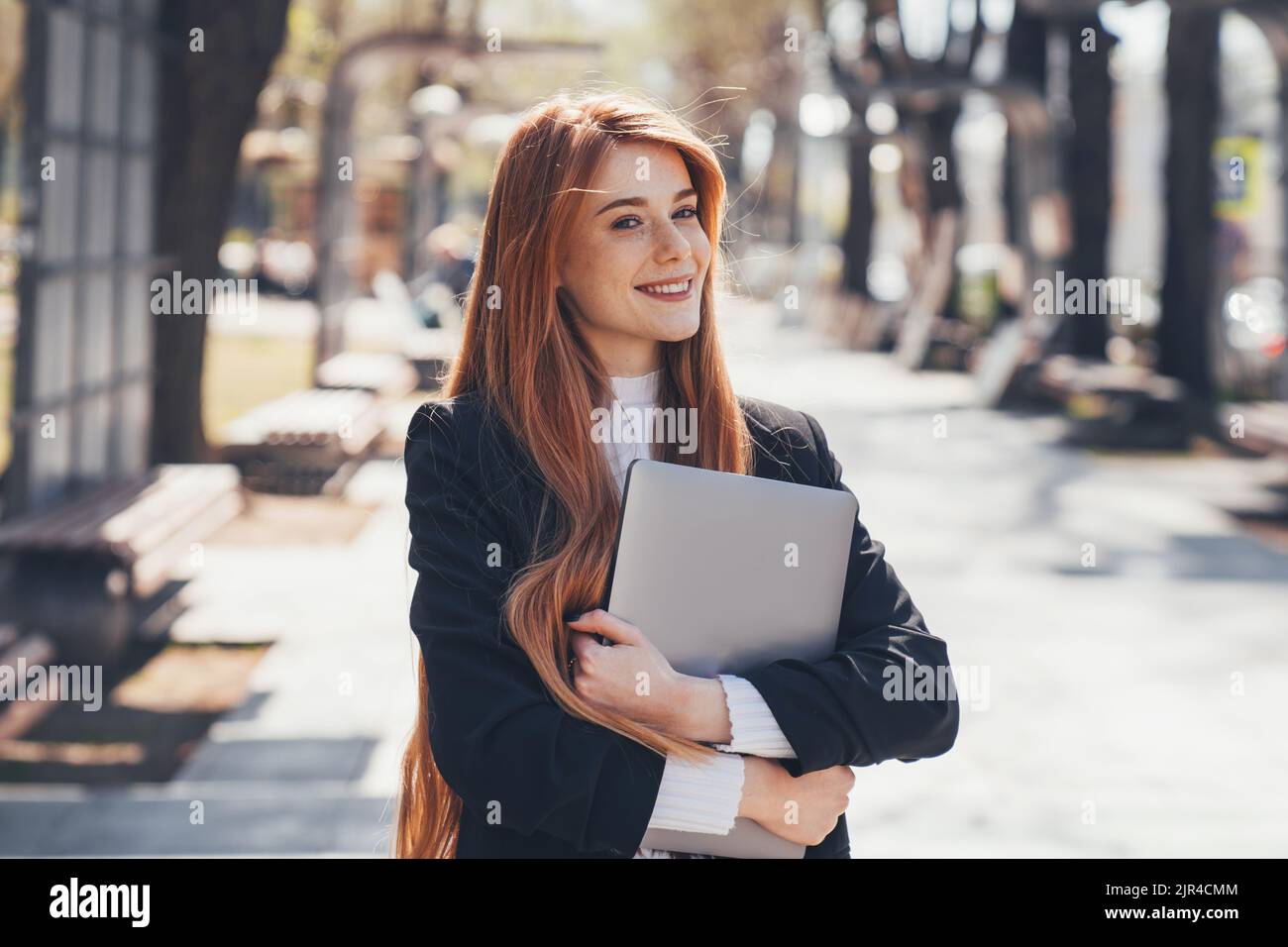 Positive good looking freckled businesswoman enjoying walk outdoor ...