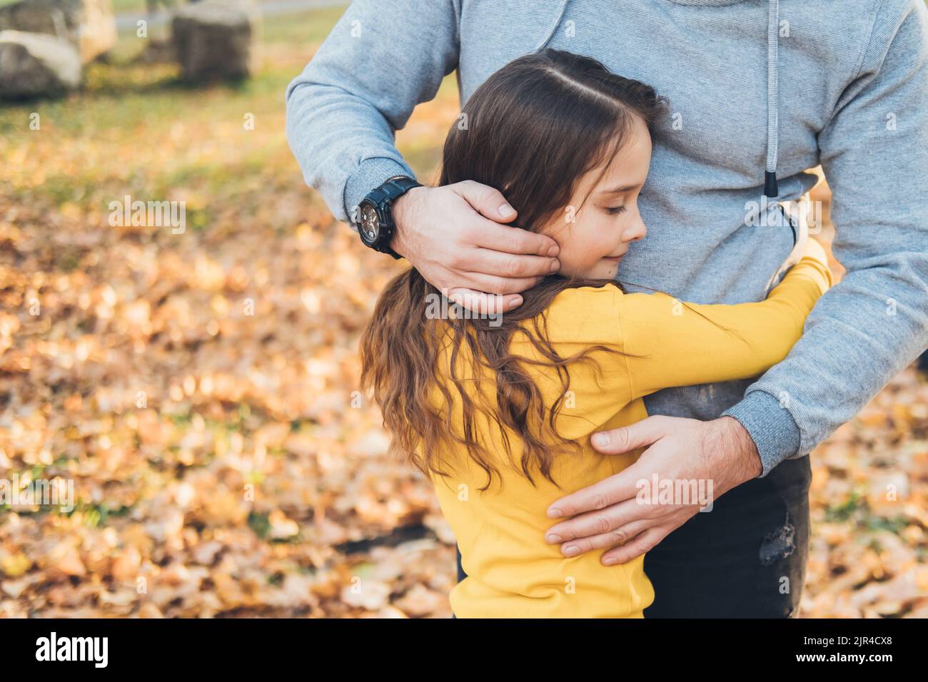 Portrait of happy daughter standing and hugging her father in the ...