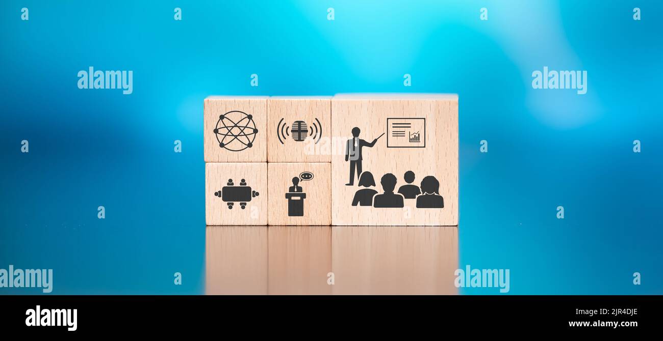 Wooden blocks with symbol of seminar meeting concept on blue background ...