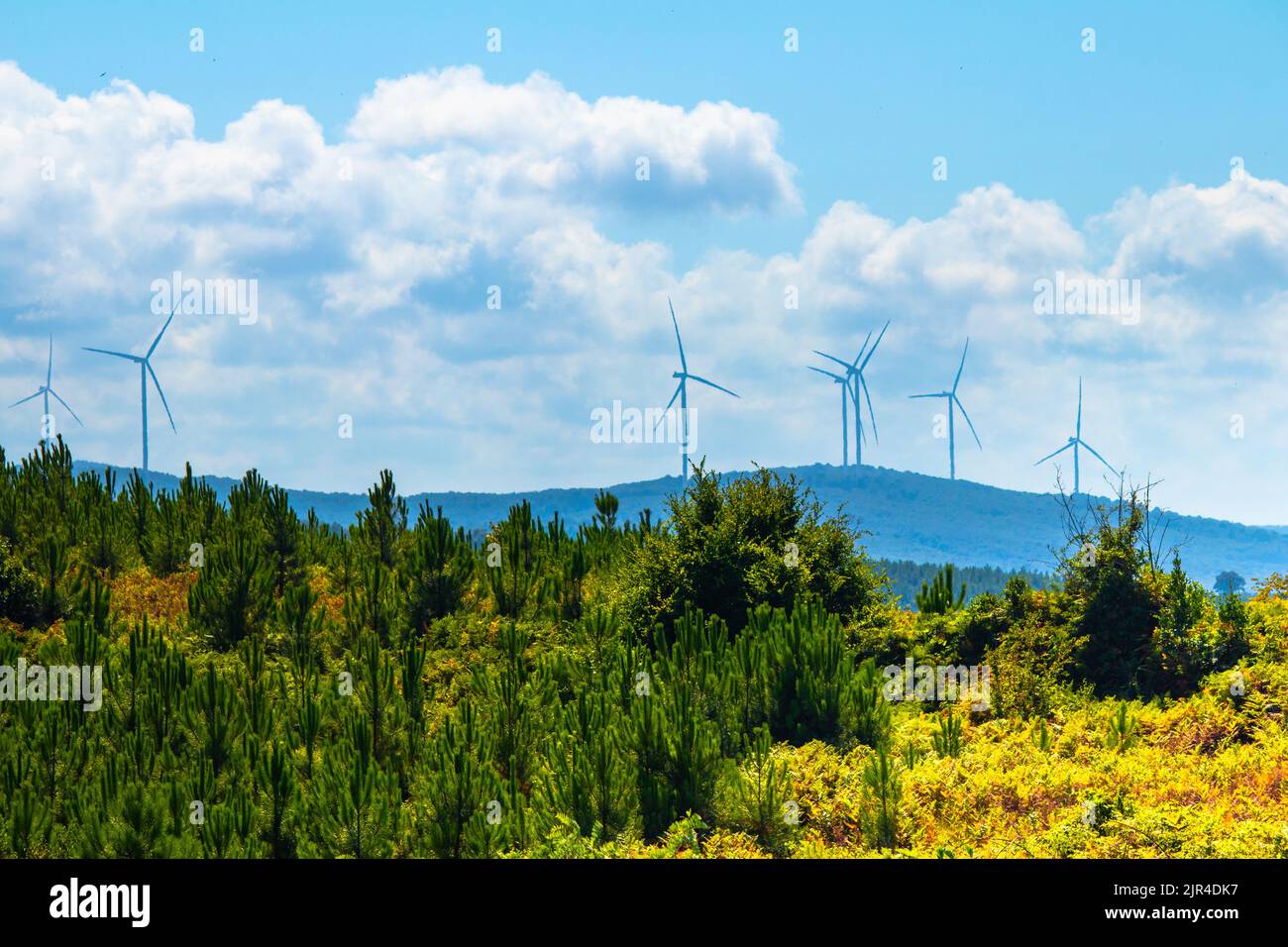 Wind turbines behind the hills, An intertwined image of nature and ...