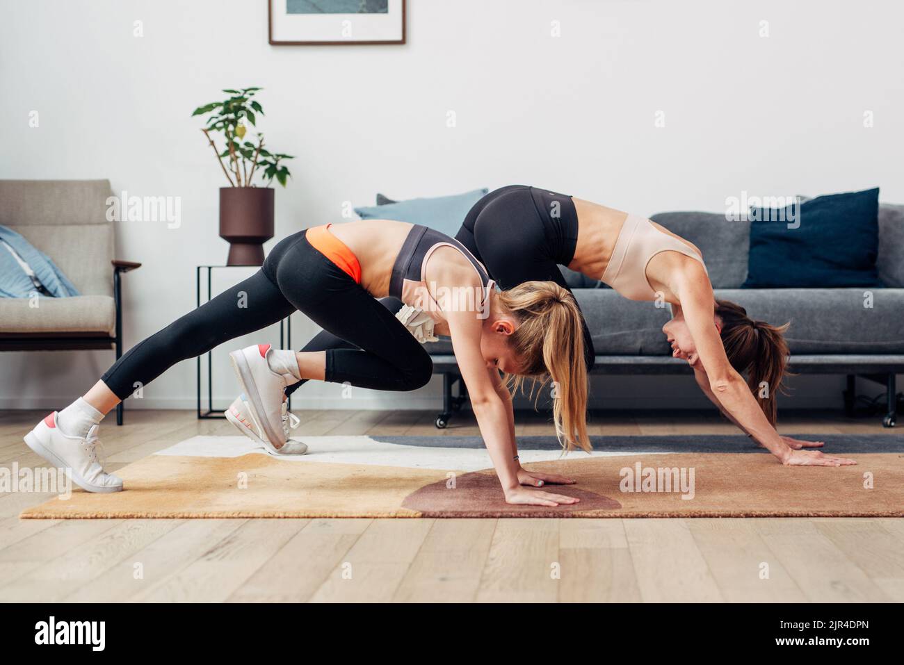 Girls doing abs exercise mountain climbers exercise at home Stock Photo ...