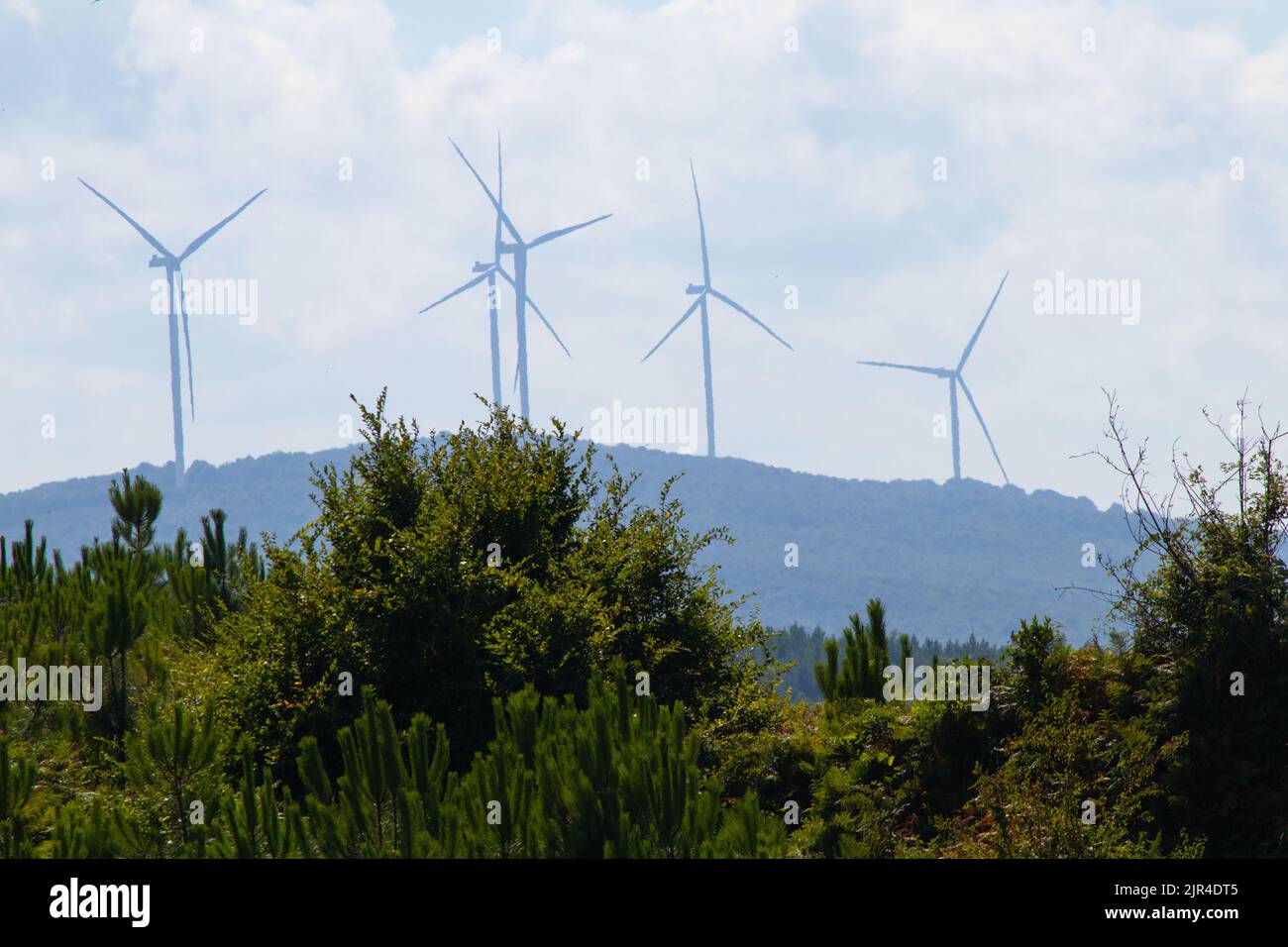 Wind turbines behind the hills, An intertwined image of nature and ...