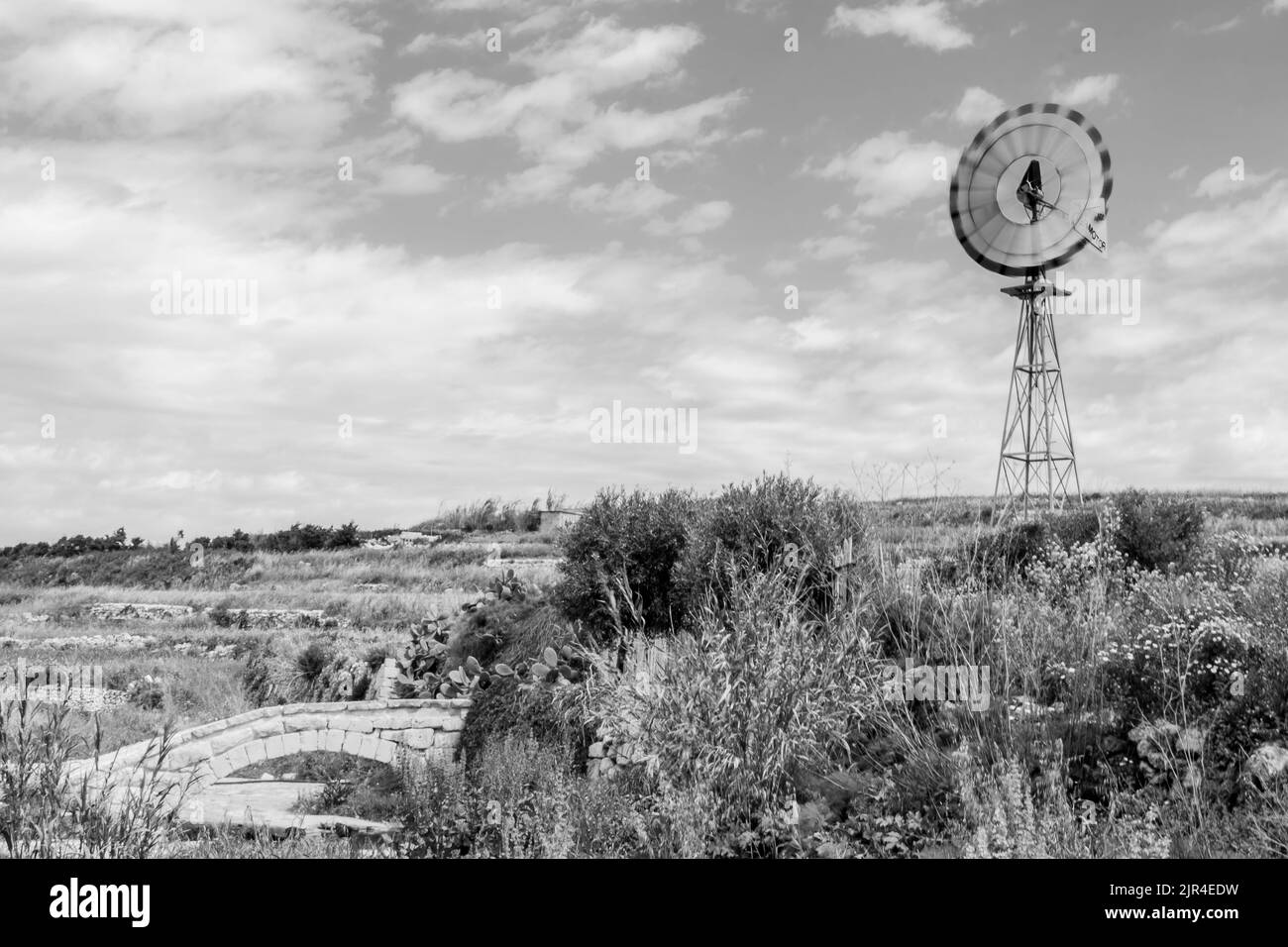 A functioning wind pump, with rotating multi bladed rotor in motion ...