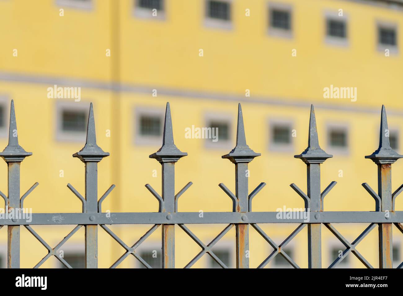 Metal fence with spikes of an old historical prison building with ...