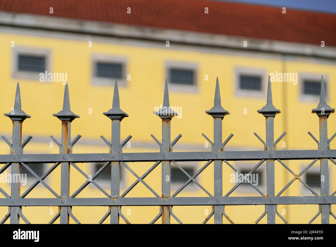 Metal fence with spikes of an old historical prison building with ...