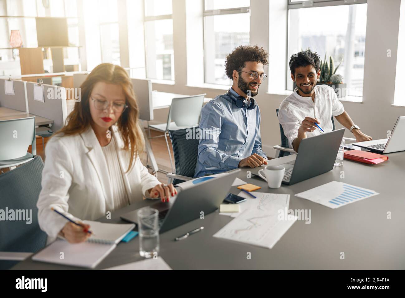 Busy coworkers cooperating and working together at office meeting ...