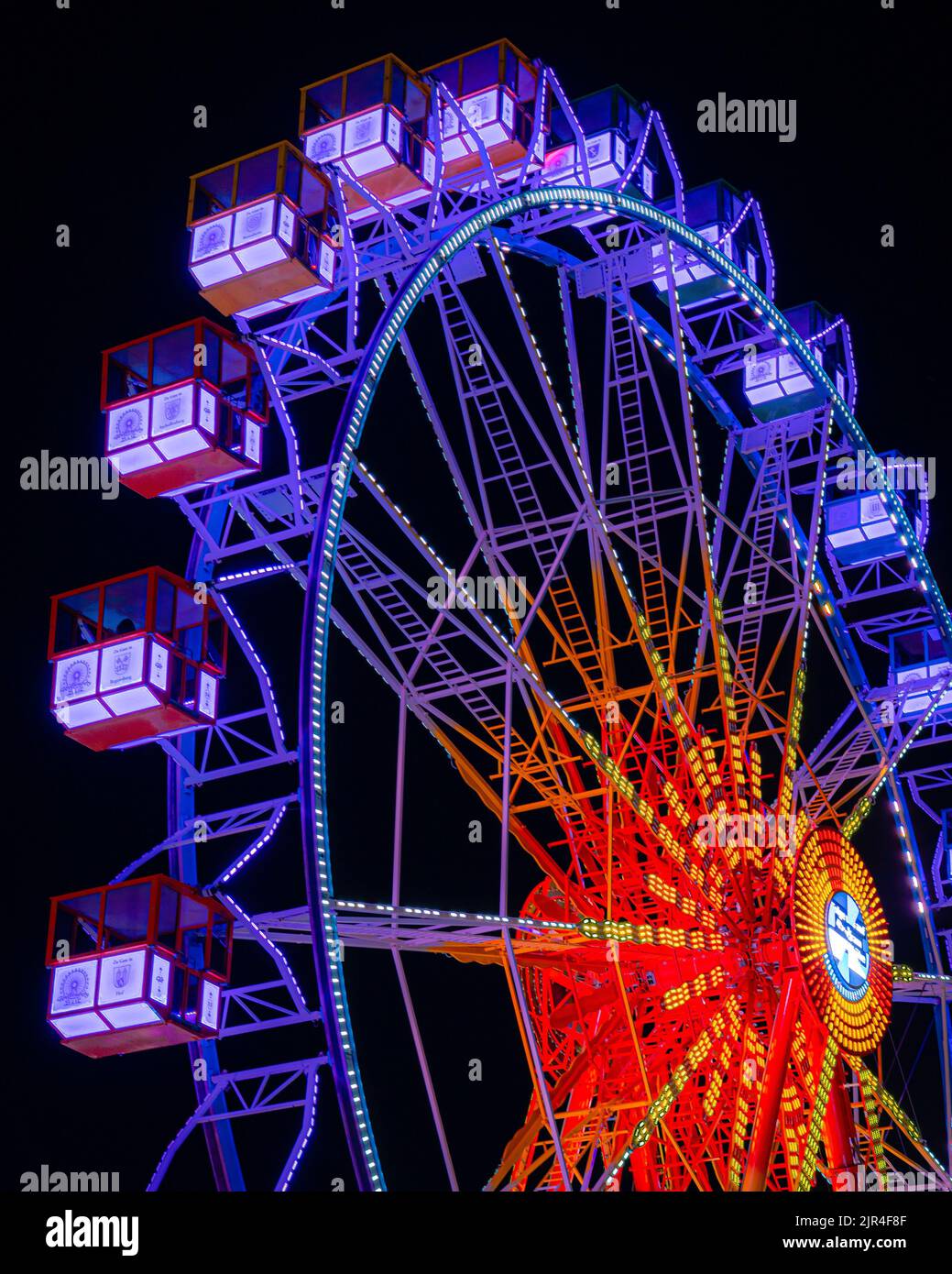 A low angle shot of a Ferris wheel illuminated at night Stock Photo - Alamy