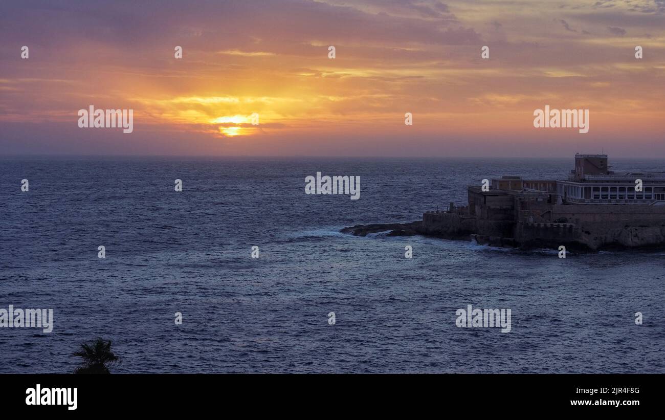 A high angle shot of a building on a coast against a sea at a beautiful ...