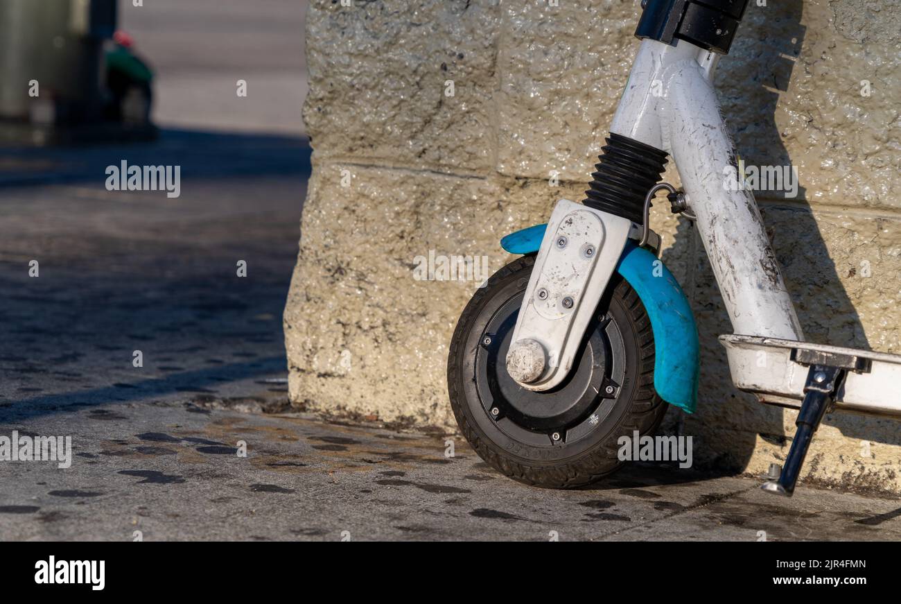 Close-up of electric scooter front wheel leaning against wall Stock ...