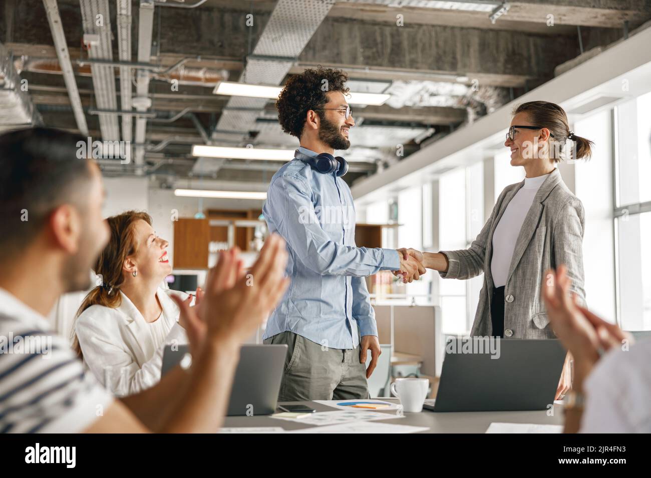 Smiling female boss leader shaking hand of new team member recruiting ...