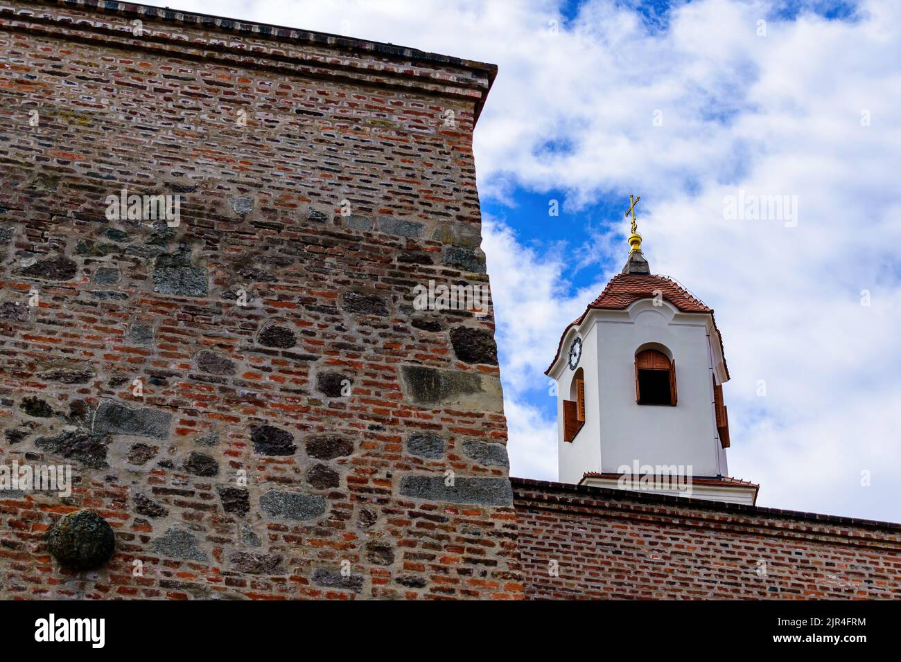 A low angle of a turret and part of the wall with a stone cannonball at ...