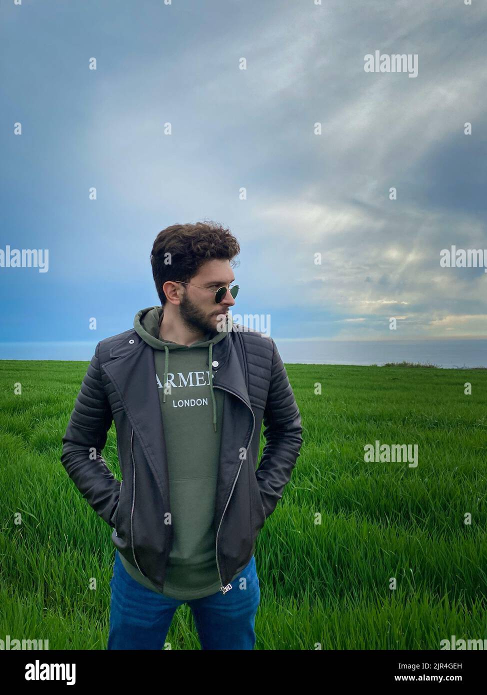 A vertical shot of a male on the background of a field in Istanbul ...