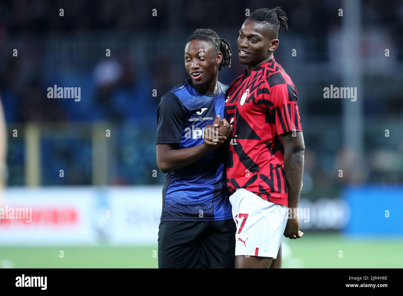 Bergamo, Italy . August 21, 2022, Brandon Soppy of Atalanta Bc speaks with Rafael Leao of Ac ...