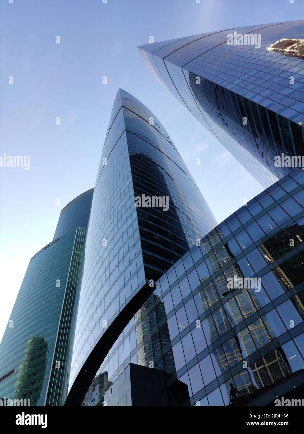 Bottom view on skyscrapers and blue sky. Modern office buildings in the ...
