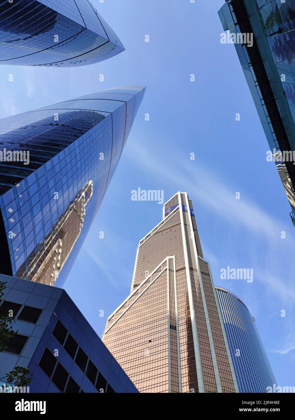 Bottom view on skyscrapers and blue sky. Modern office buildings in the ...