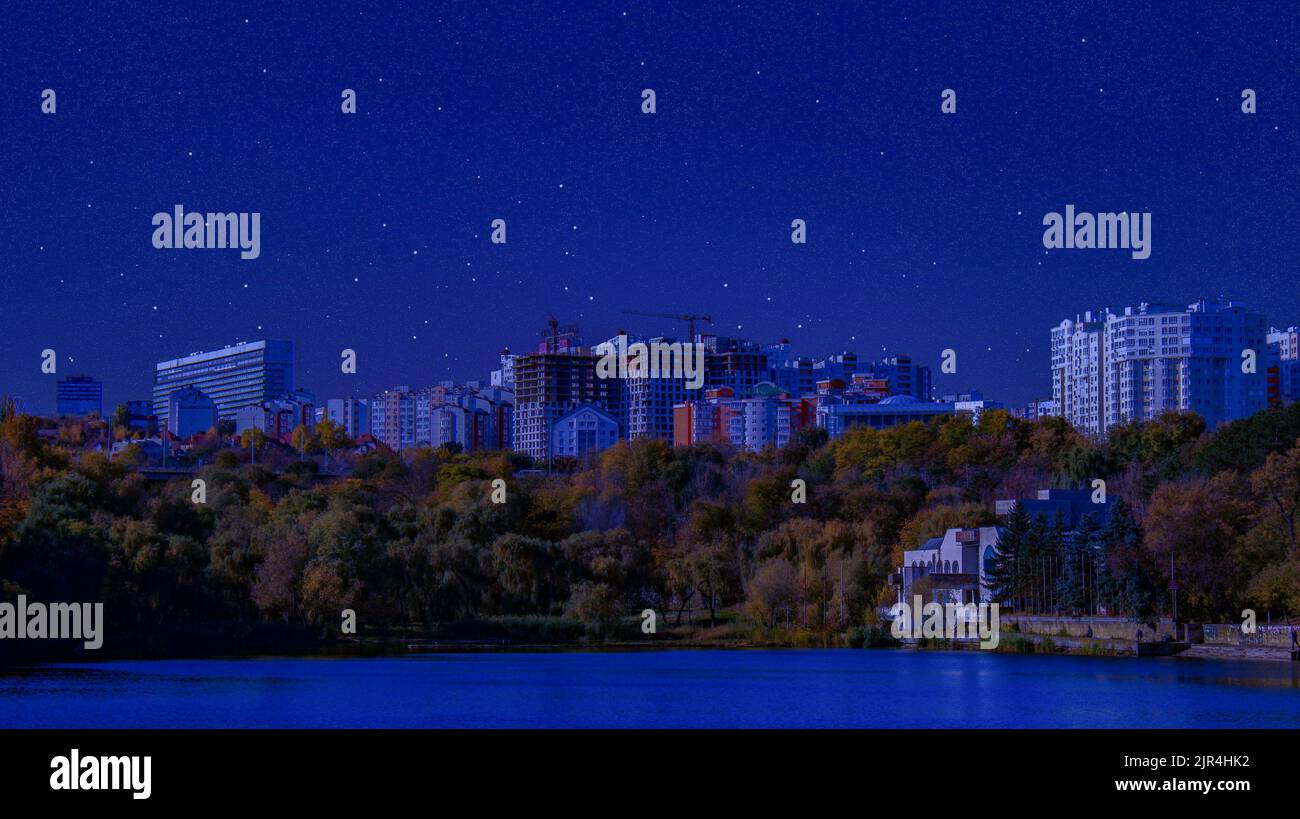 Downtown with a building in construction at night with a sky full of ...