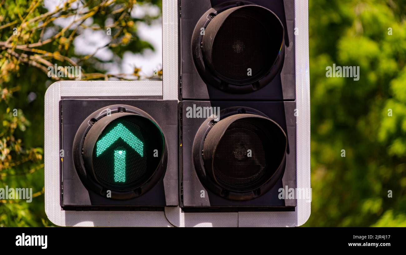 Green Traffic Light with Arrow Signal in Daylight Stock Photo - Alamy