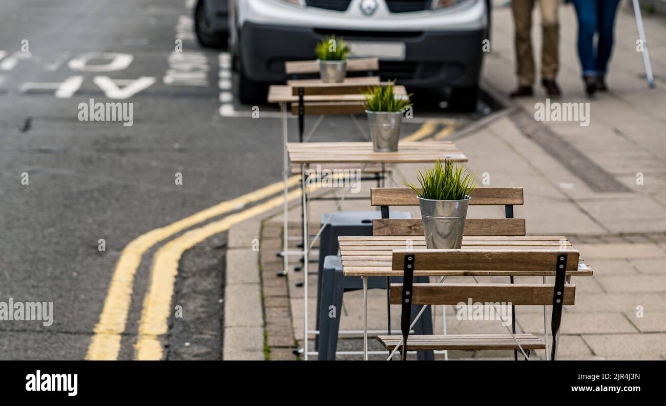 Outdoor Café Table with Potted Plant on Pavement Stock Photo - Alamy