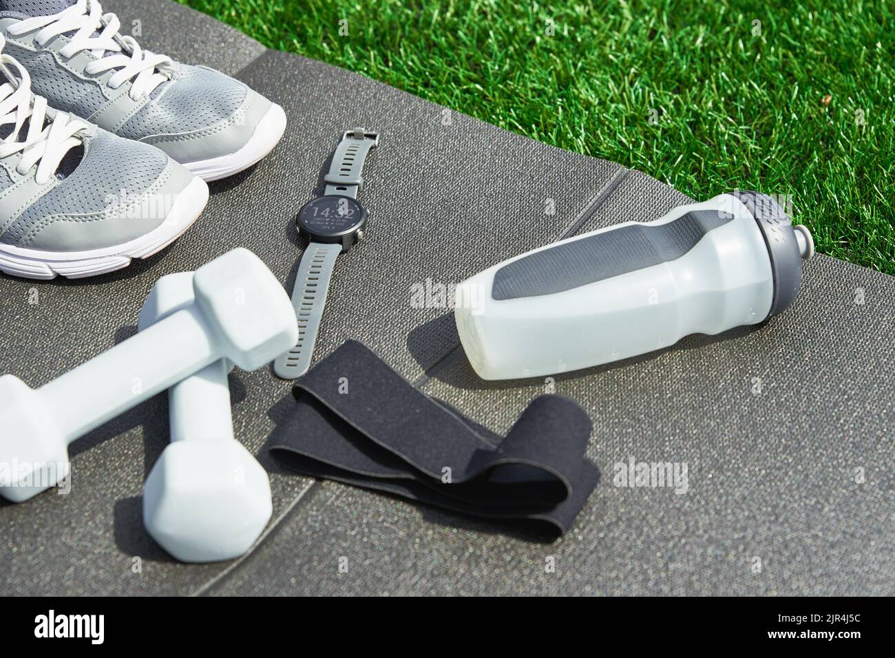 Sport items, fitness smart watches and running sneakers on gray ...