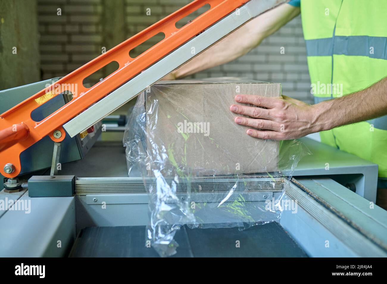 Experienced warehouse operator using automated packaging system Stock ...