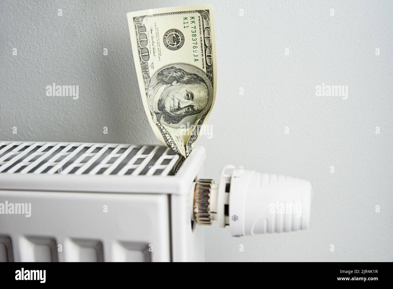 Heating radiator with dollar bills closeup, Energy crisis concept ...