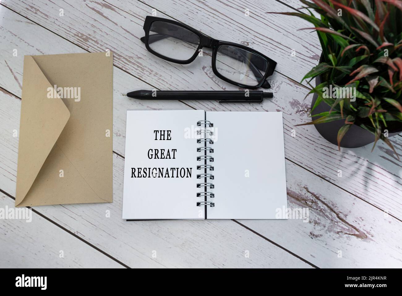 THE GREAT RESIGNATION text on notepad with brown envelop, reading ...