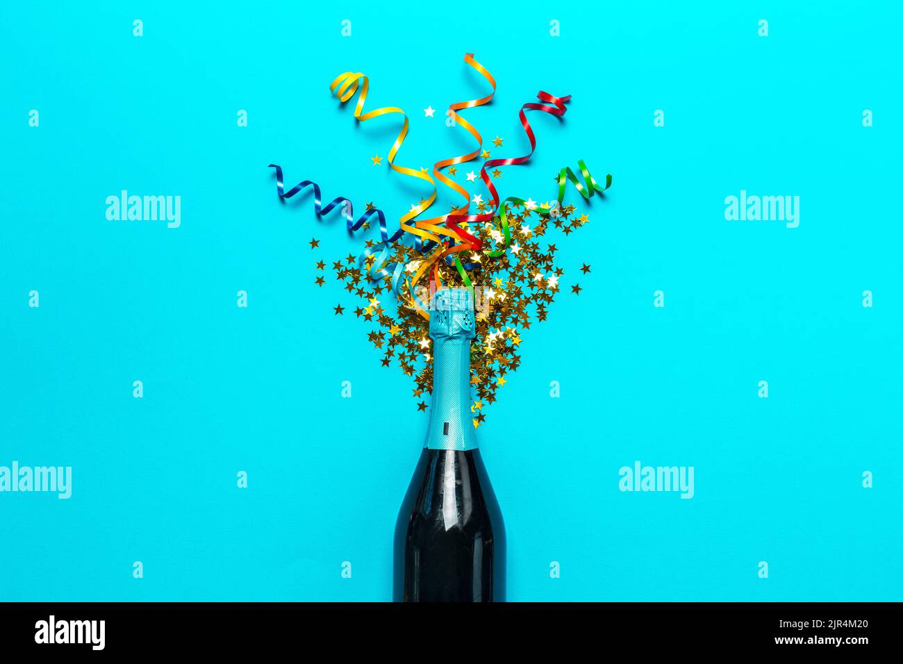 Champagne bottle with colorful party streamers Stock Photo - Alamy