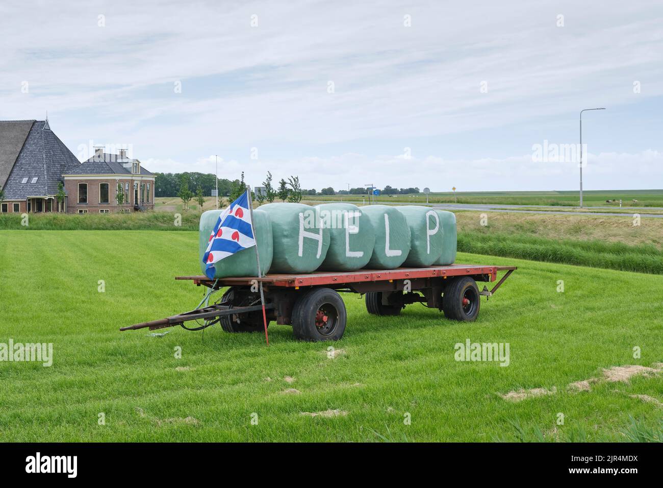 Sign in agricultural field with text Help and flag. Farmers in the ...