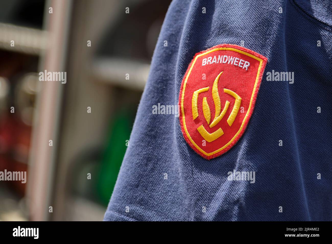 Dutch fire department badge on a firefighter's shirt. Dutch gold and ...