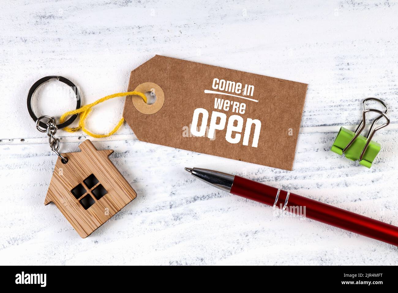 Come in we're open. Cardboard price tag with text Stock Photo - Alamy