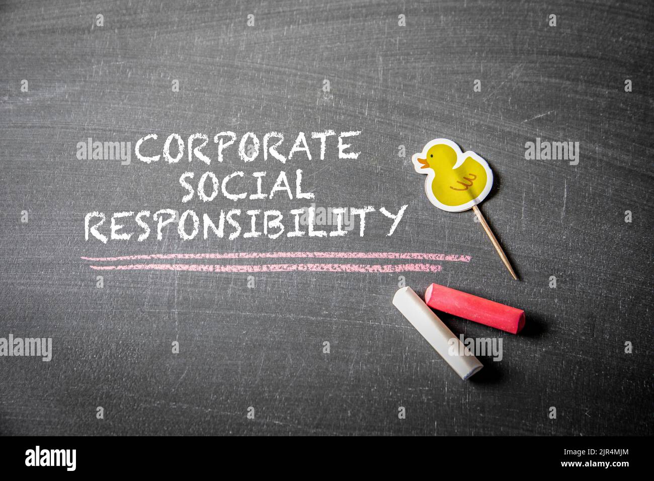 Corporate Social Responsibility. Text and pieces of chalk on a ...